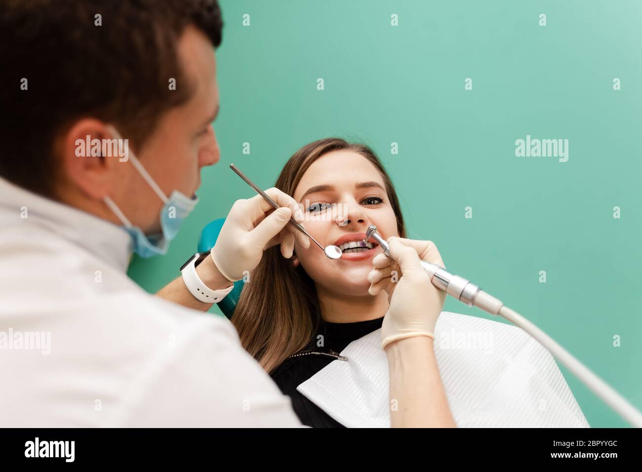 Dentist performs professional polishing of tooth enamel for woman ...