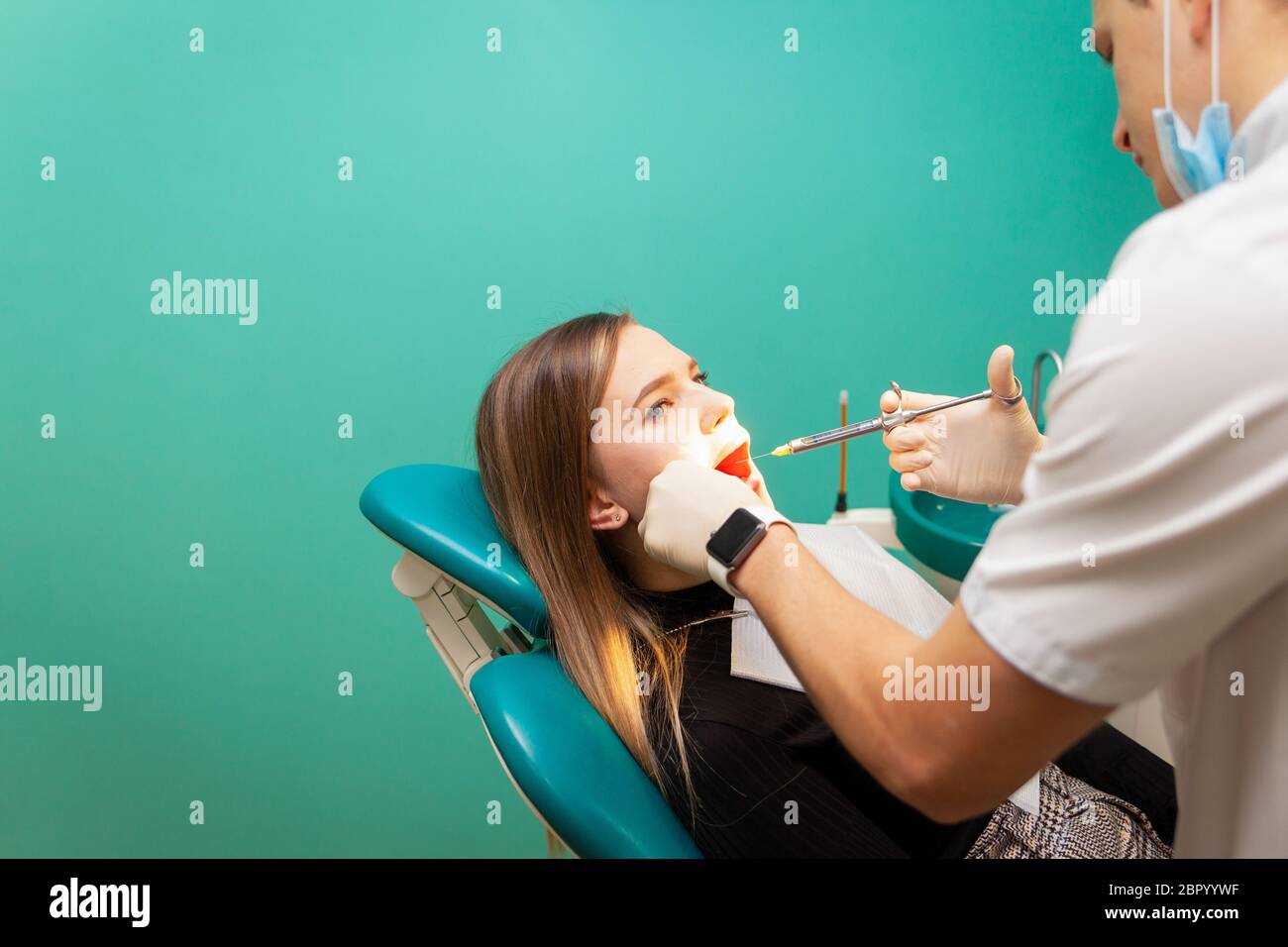 Patient woman is given an analgesic injection to treat a tooth. Dentist ...