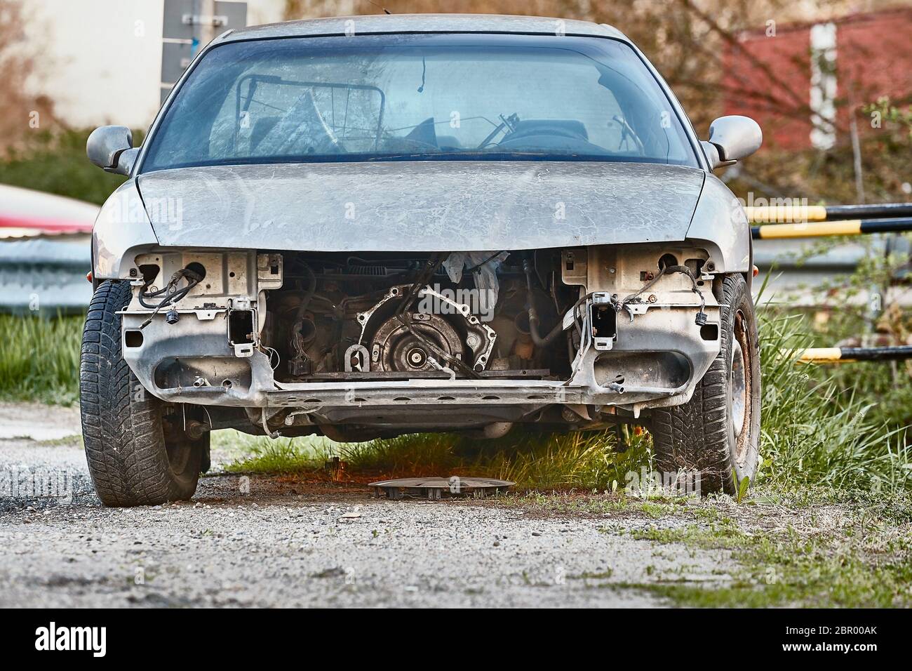Front part of a wrecked car wreck with missing engine Stock Photo - Alamy