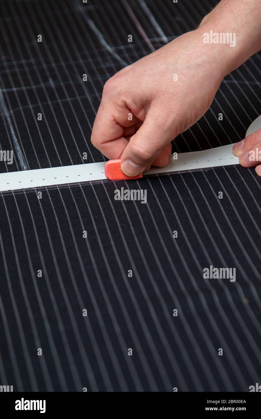 A tailor carefully measuring cloth while making a men suit. designer ...