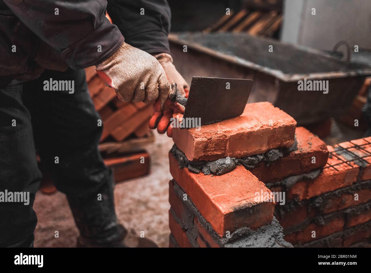 Construction site builder puts wall hi-res stock photography and images ...