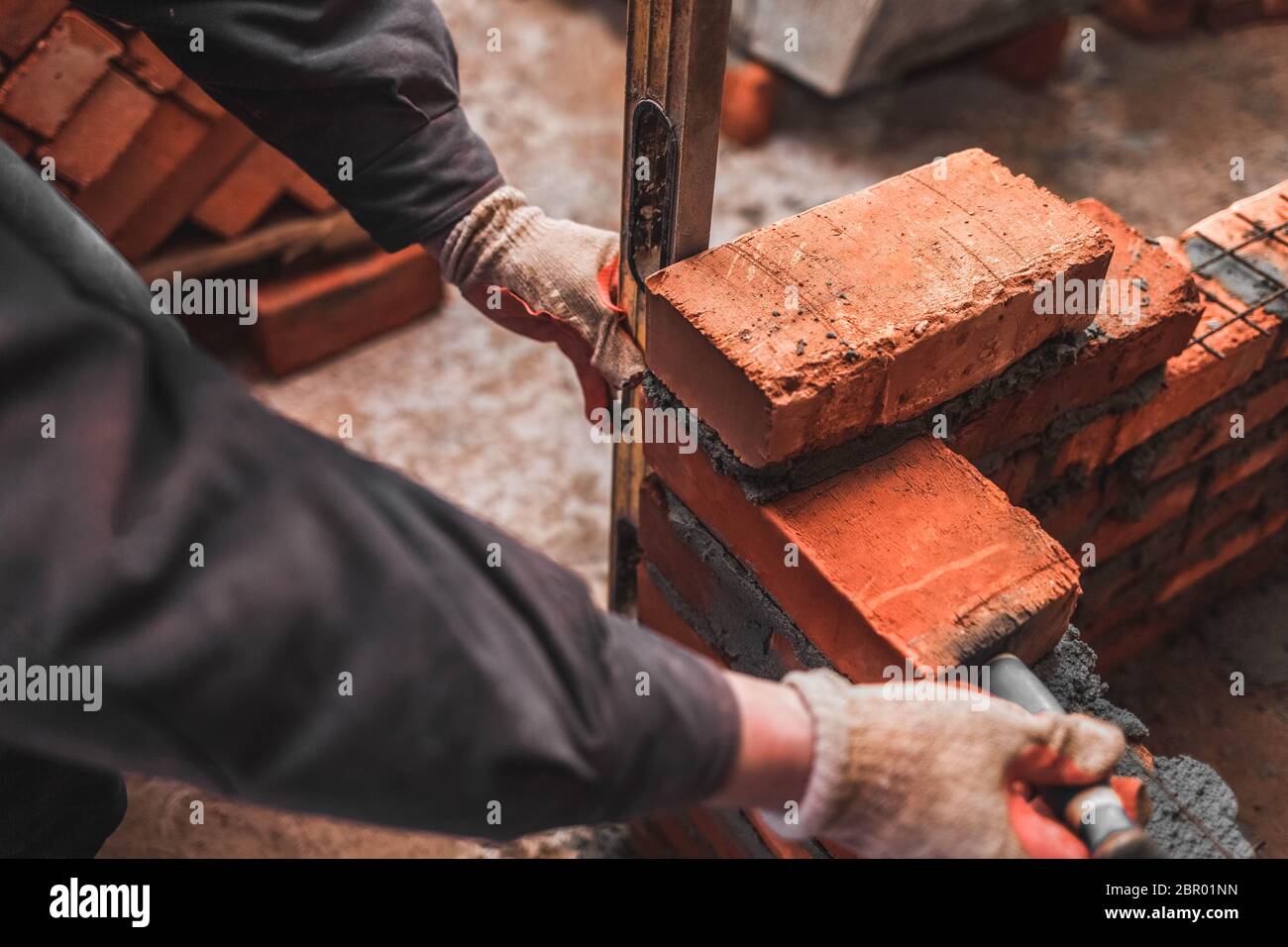Bricklayer puts bricks to make a wall Stock Photo - Alamy