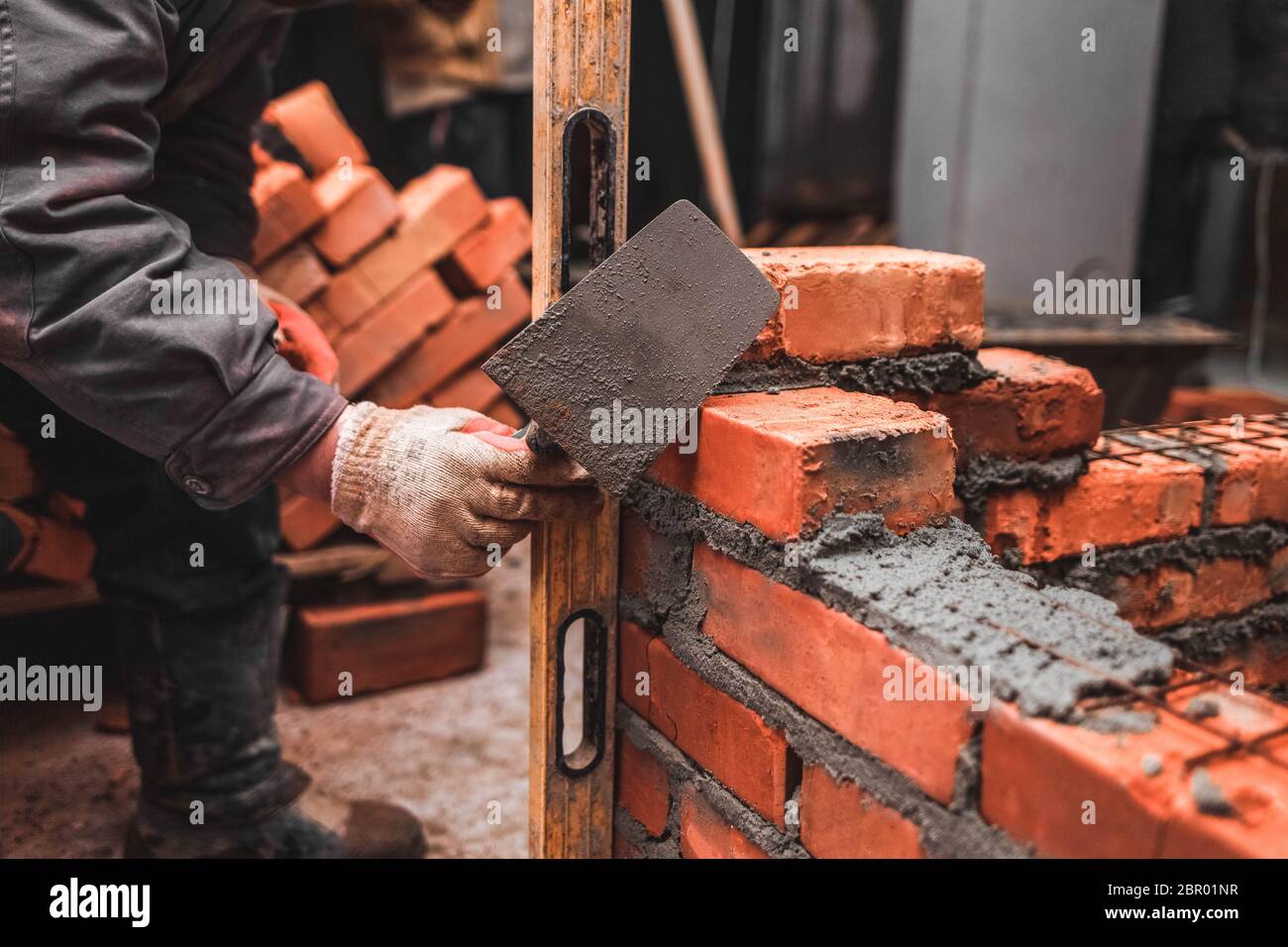 Construction site builder puts wall hi-res stock photography and images ...