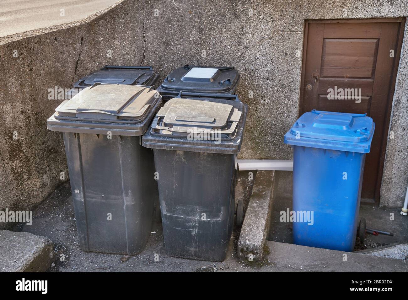 Trash containers for a block of flats, communal waste Stock Photo - Alamy