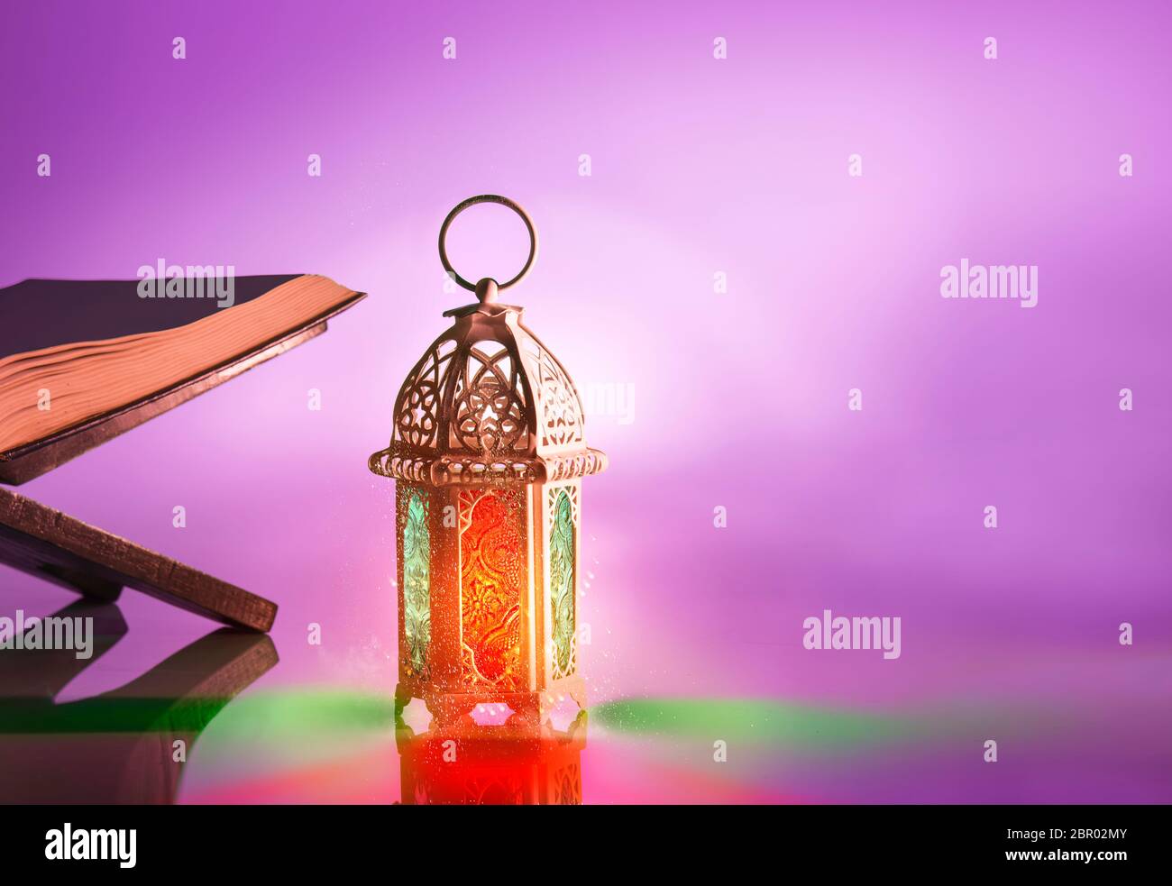 Arabic lamp with beautiful light and holy koran. Islamic concept image ...