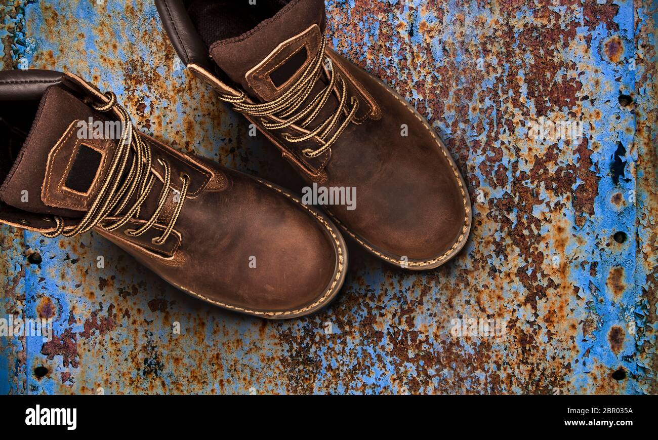 Men's brown boots on old rusty background. Closeup isolated Stock Photo ...