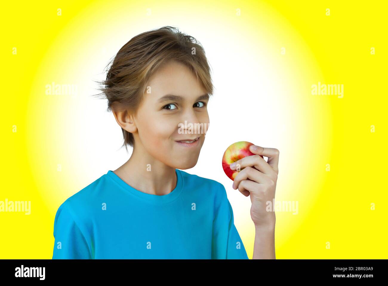 Portrait casual young man eating apple, against a white wall Stock ...