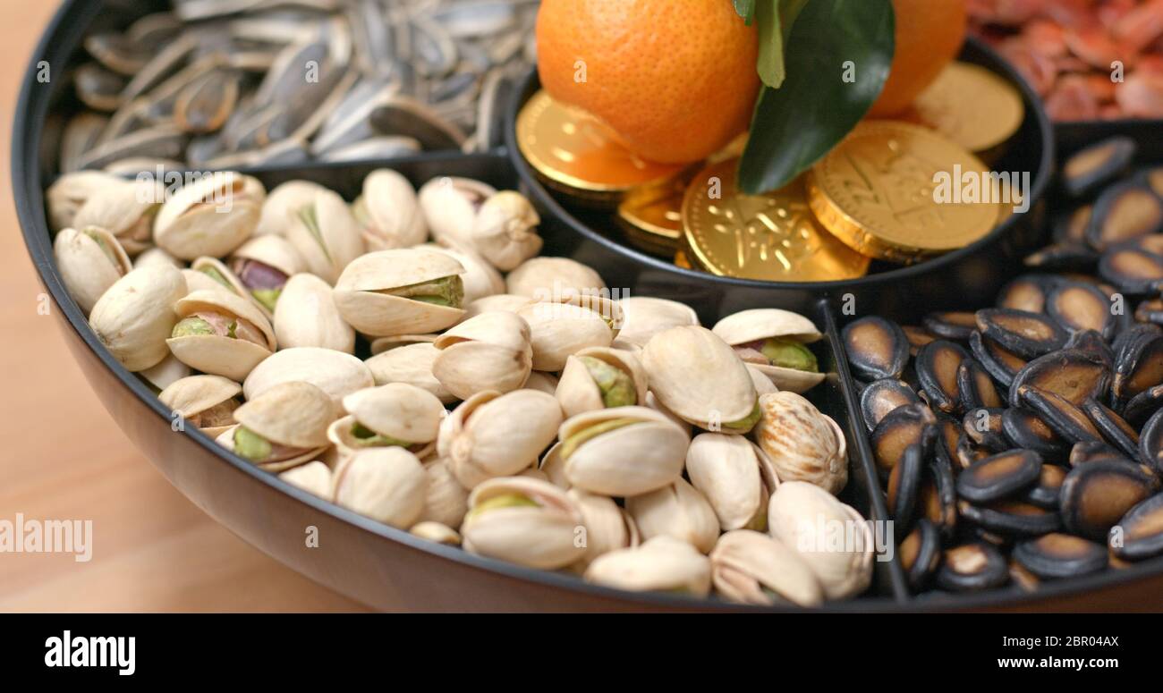 Lunar new year snack tray with gold coin candy with words wealth Stock ...