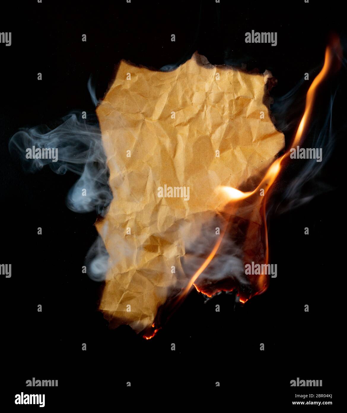 burning piece of crumpled paper on black background Stock Photo - Alamy