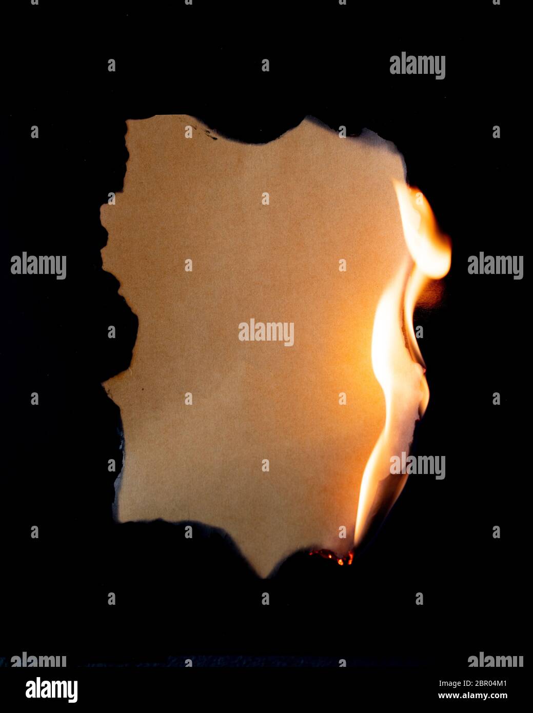 burning piece of paper on black background Stock Photo - Alamy