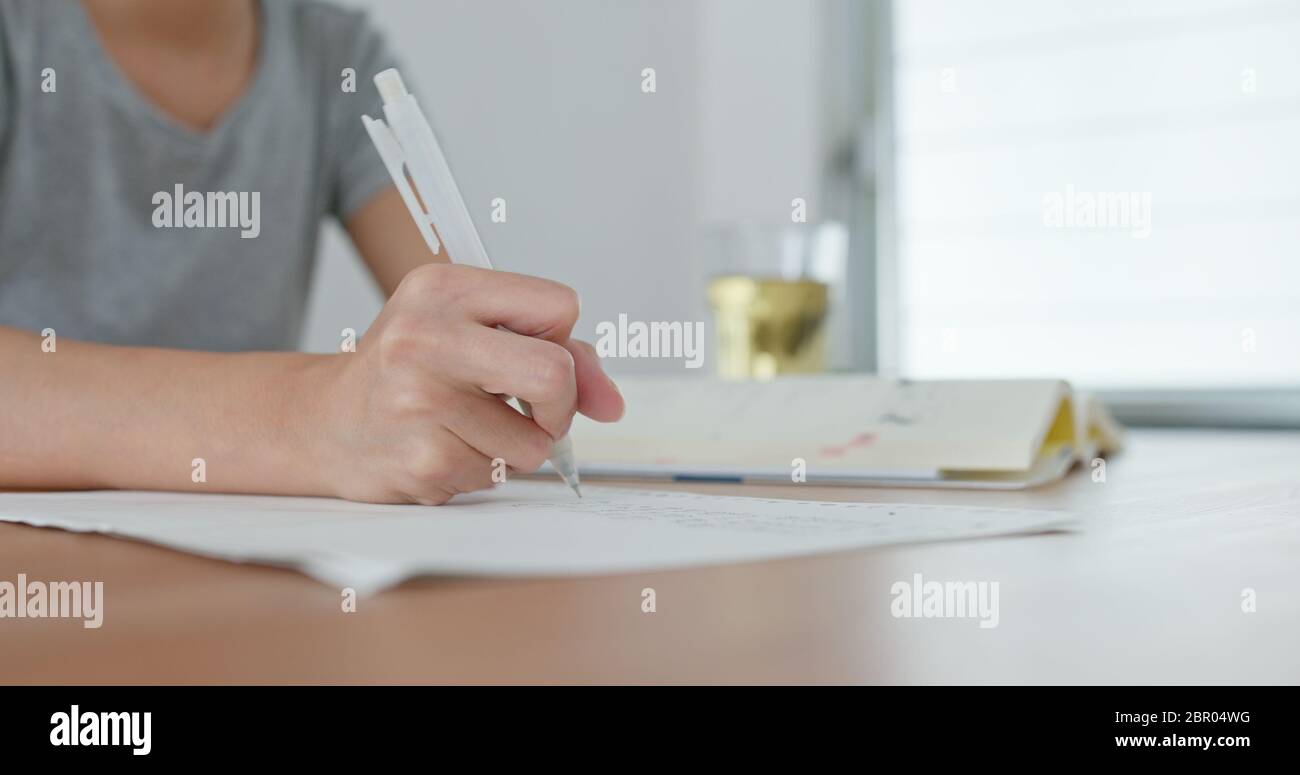 Woman take note on paper at home Stock Photo - Alamy