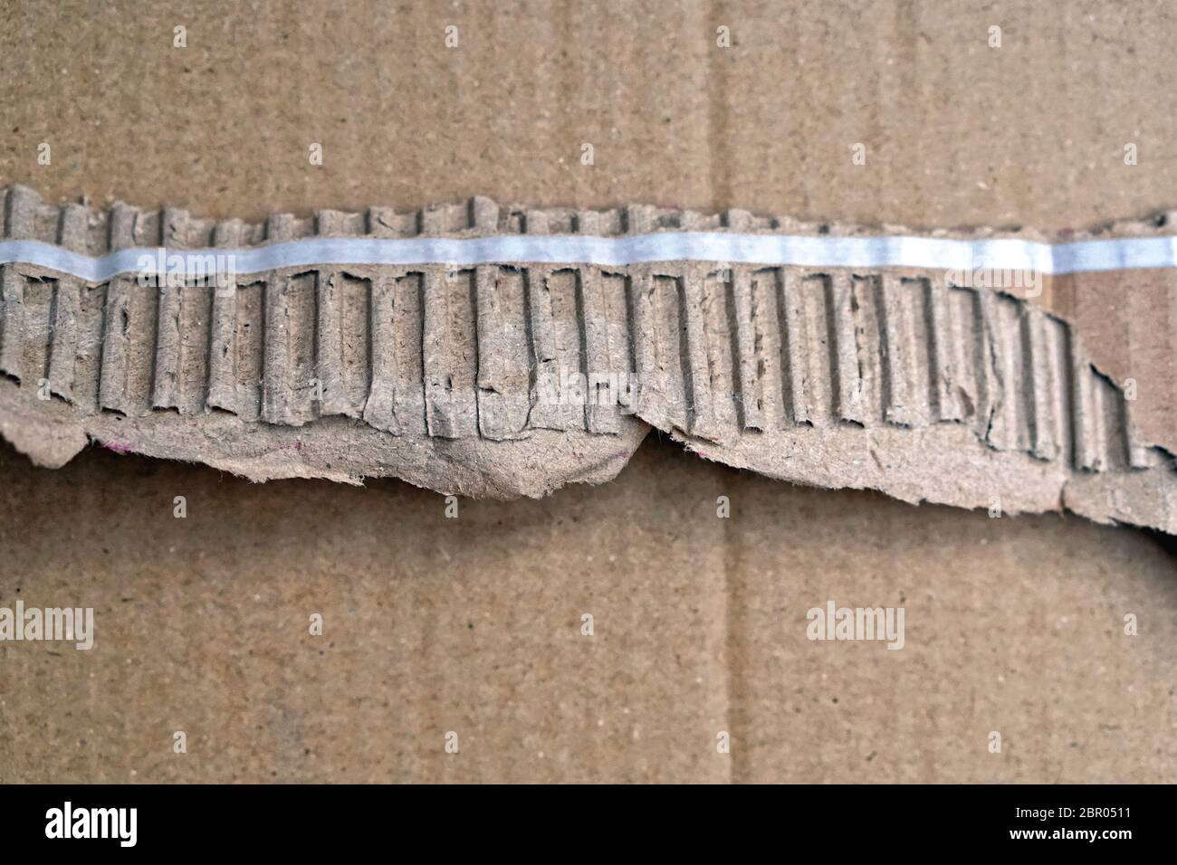 Pull to open strip at cardboard box Stock Photo - Alamy