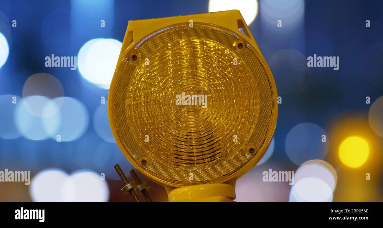 Yellow caution light at night Stock Photo - Alamy