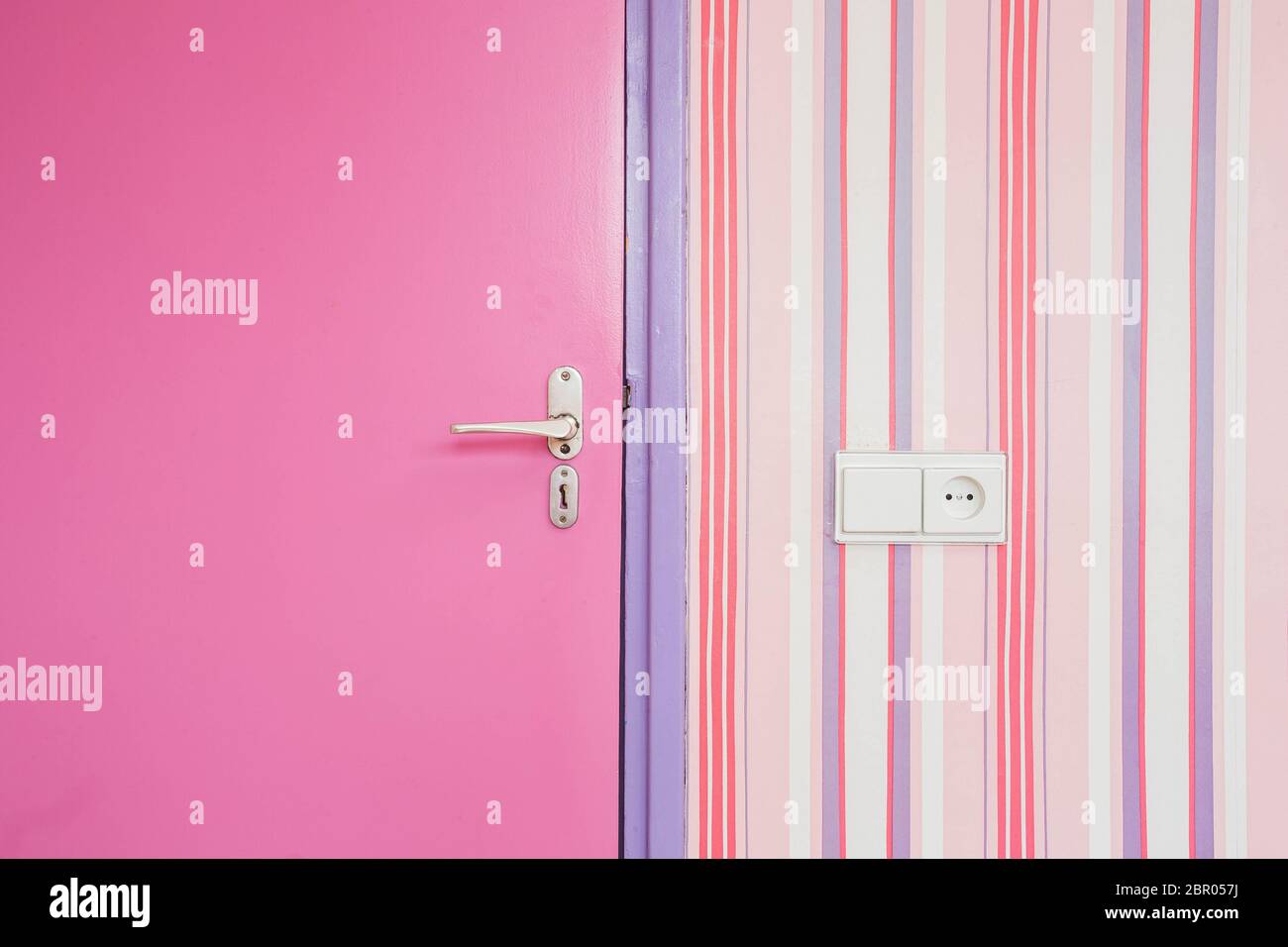 pink door with pink striped wallpaper closeup, girly design interior ...
