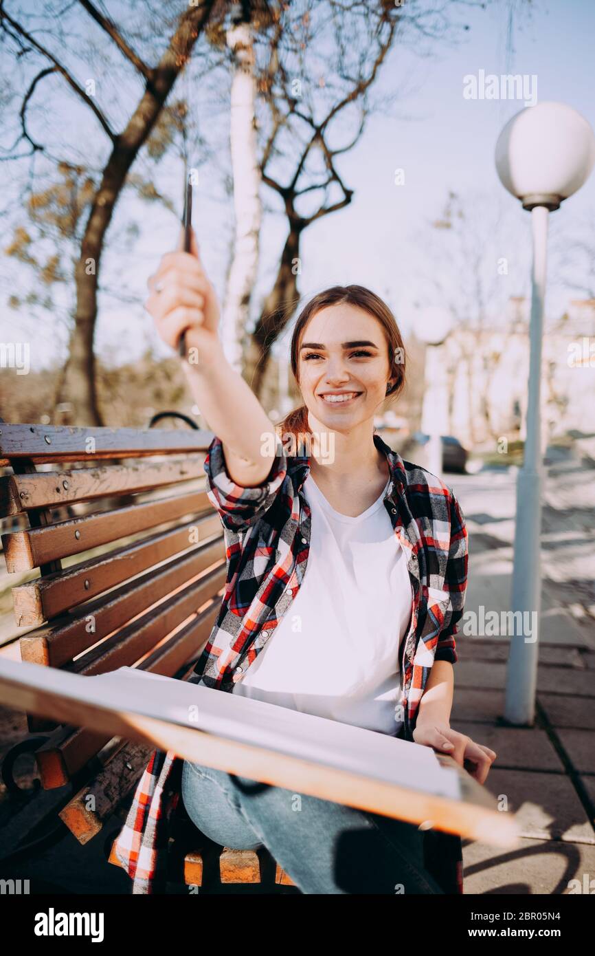 Artist measures proportions with a pencil. Painting process Stock Photo ...