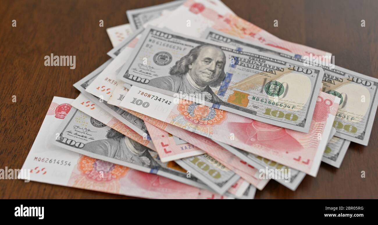 Counting with chinese RMB and USD banknote Stock Photo - Alamy