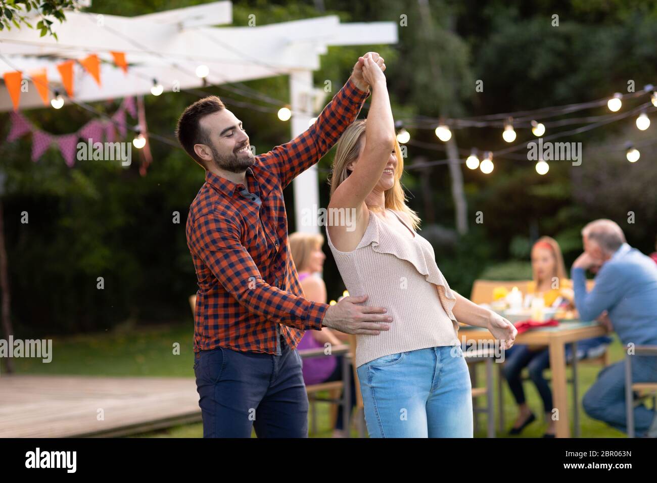 Happy couple dancing in the garden Stock Photo - Alamy
