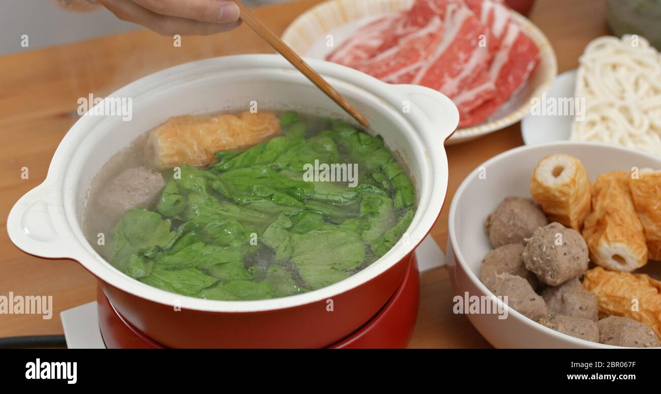 Family enjoy hot pot dinner together Stock Photo - Alamy