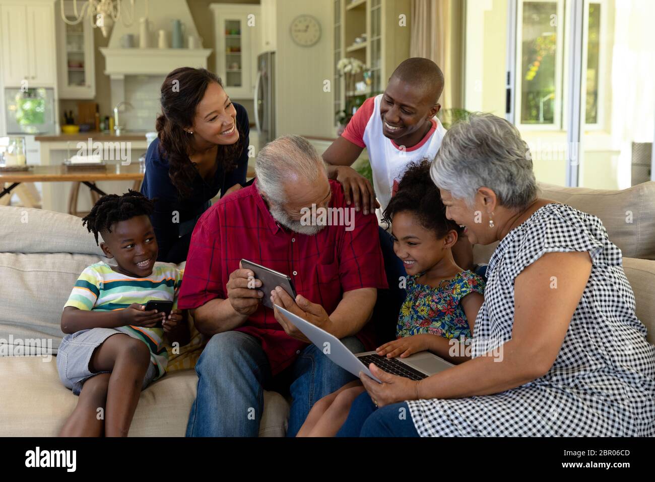 Multi-generation mixed race family at home Stock Photo - Alamy