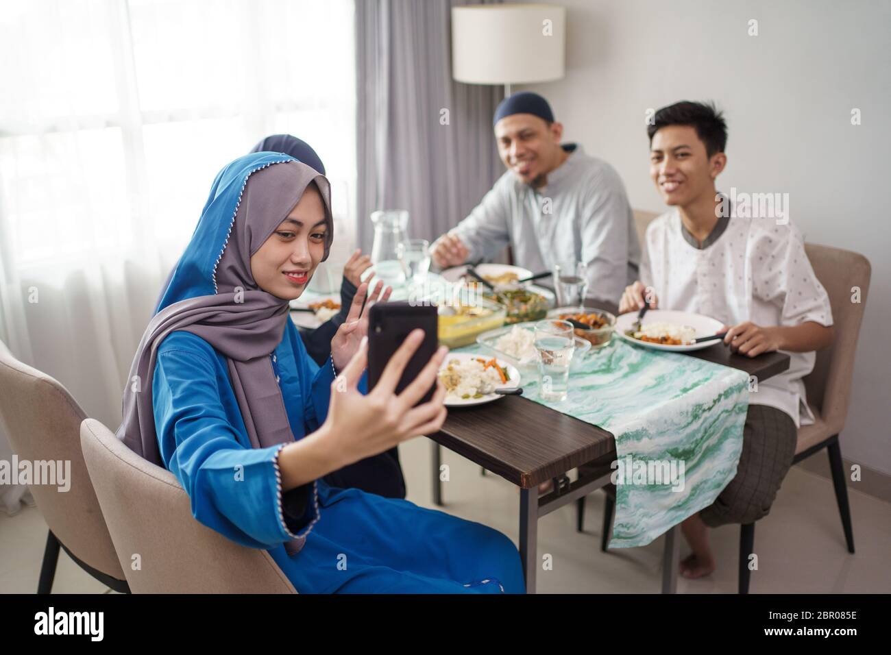 muslim family video calling and confrence with friend using mobile ...