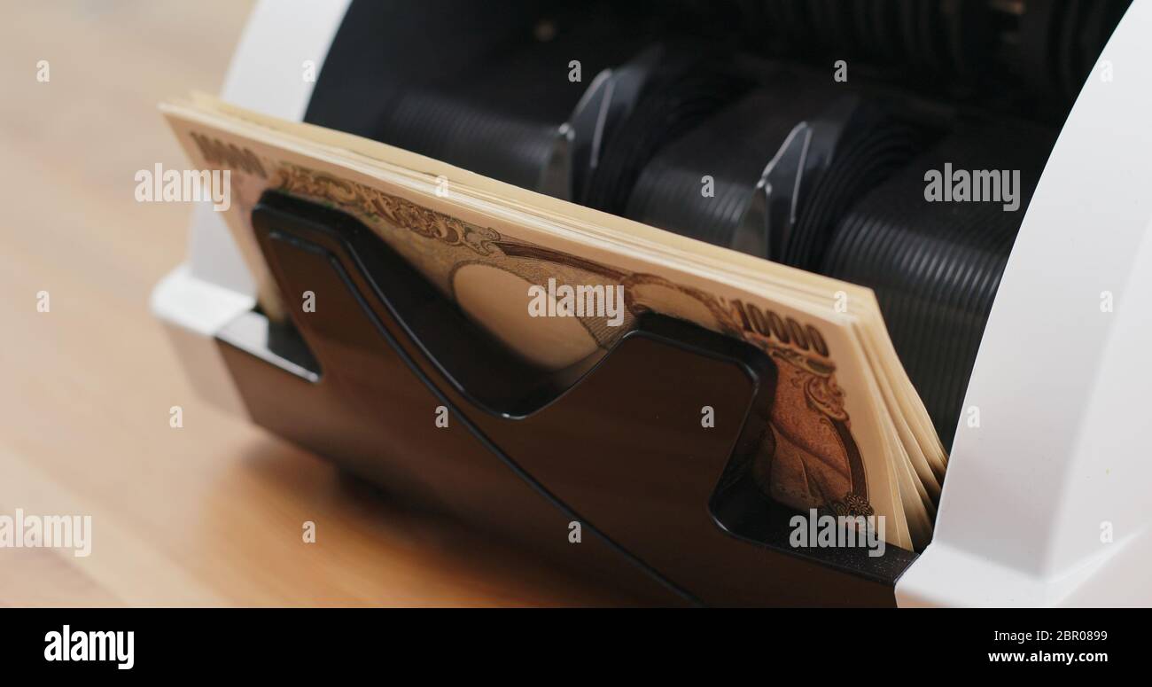 Japanese banknote on Money counting machine Stock Photo - Alamy