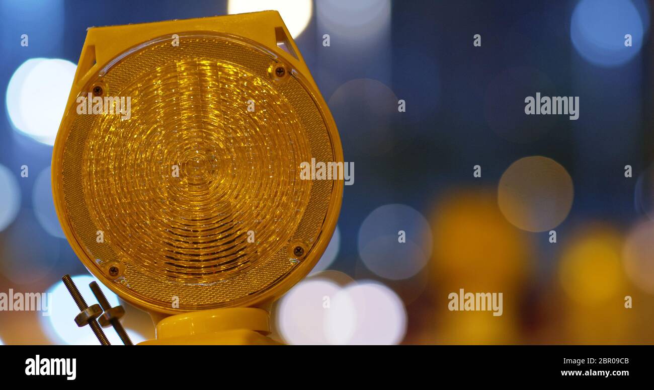 Yellow caution light in the street at night Stock Photo - Alamy