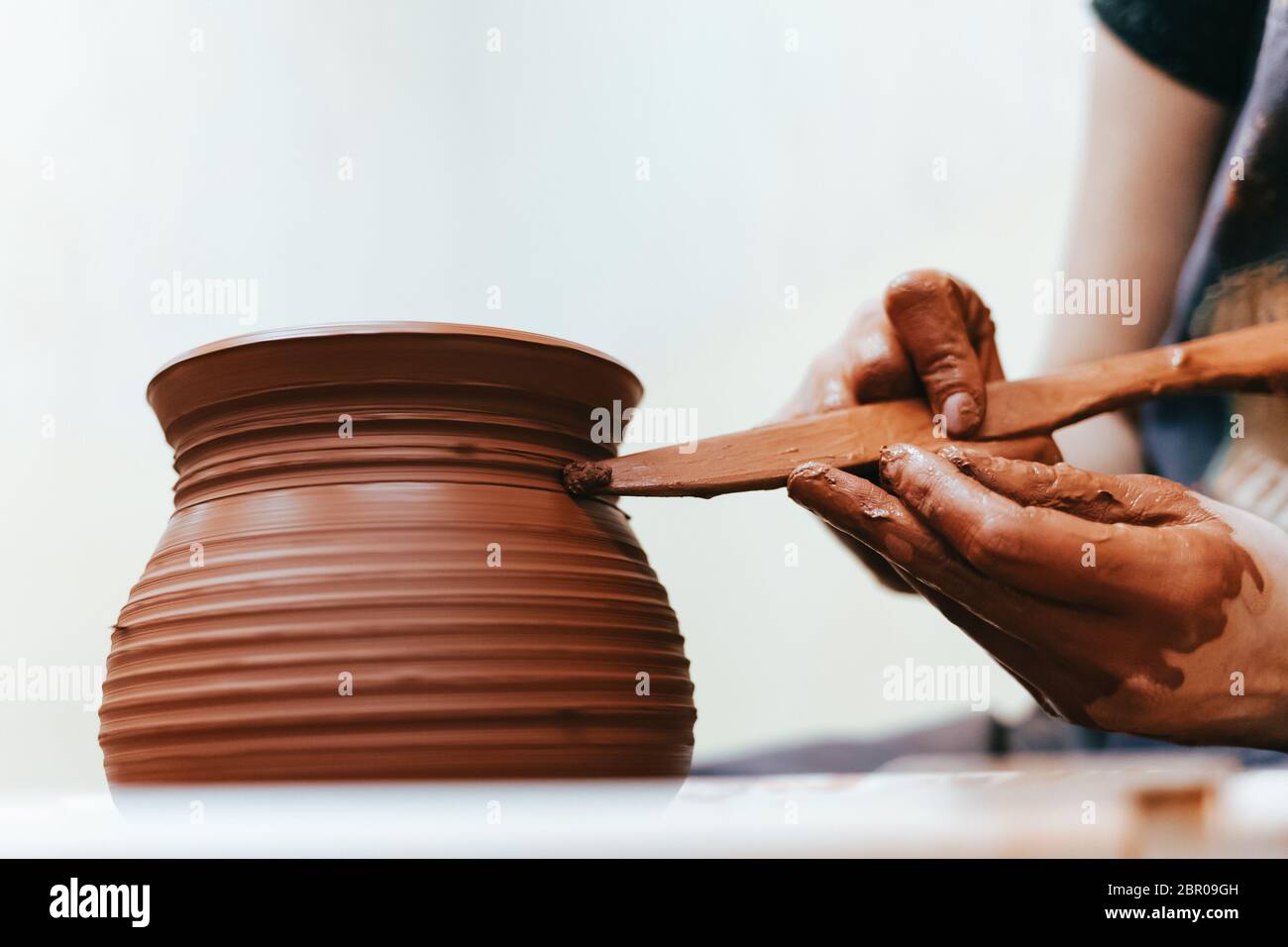 Girl works behind a pottery wheel forms a jug to perfect forms Stock ...