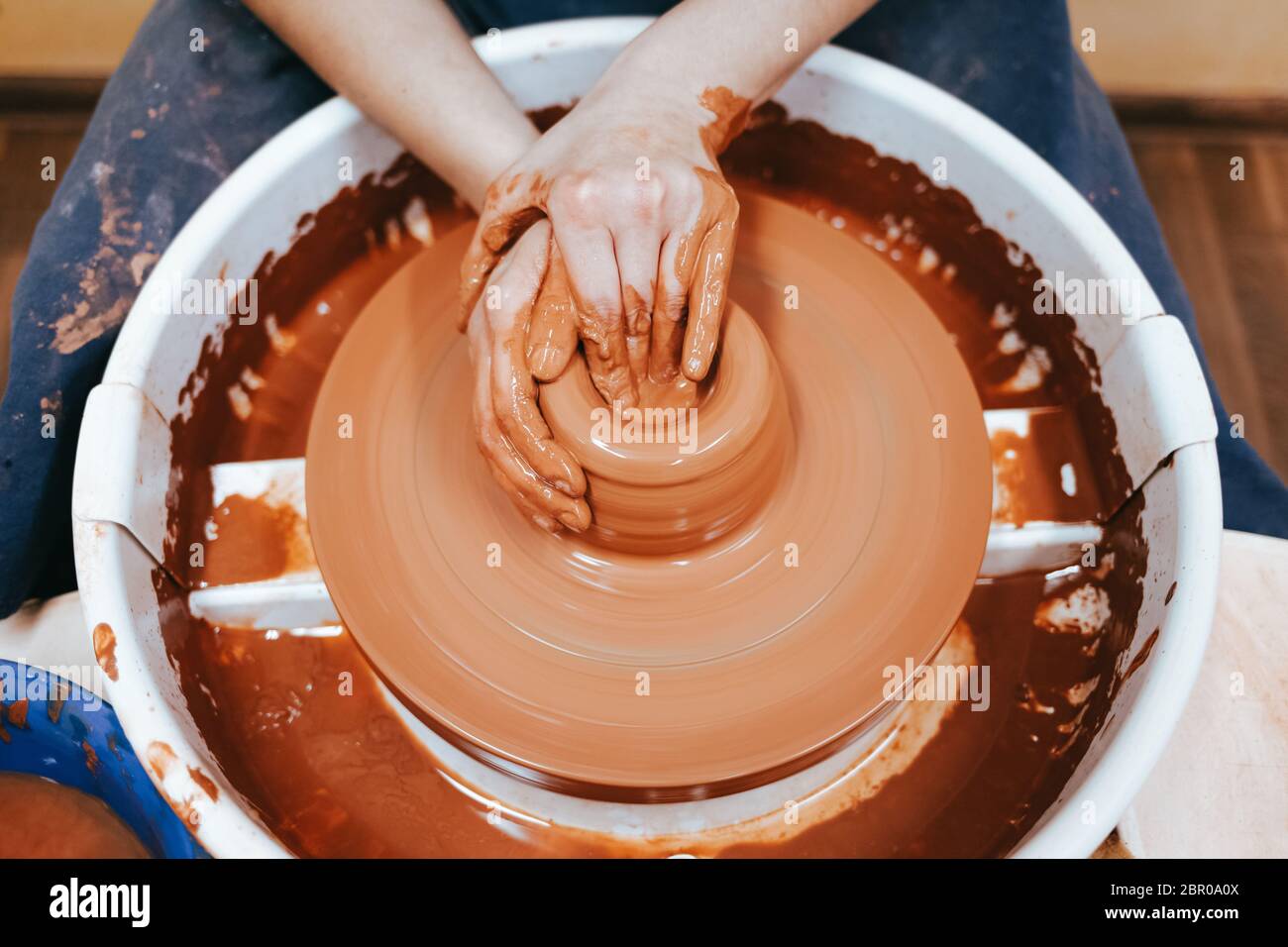 Potter forms a clay jug. Process of creating ceramic products. Woman ...