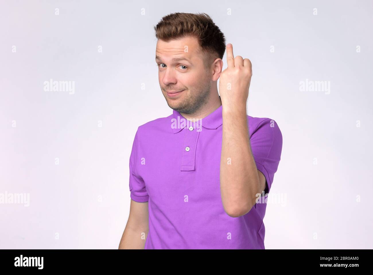 Caucasian young man showing empty ring finger being divorced. Studio ...