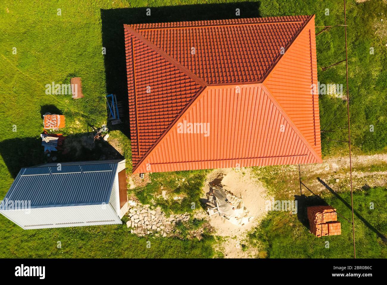 House with an orange roof made of metal, top view. Metallic profile ...