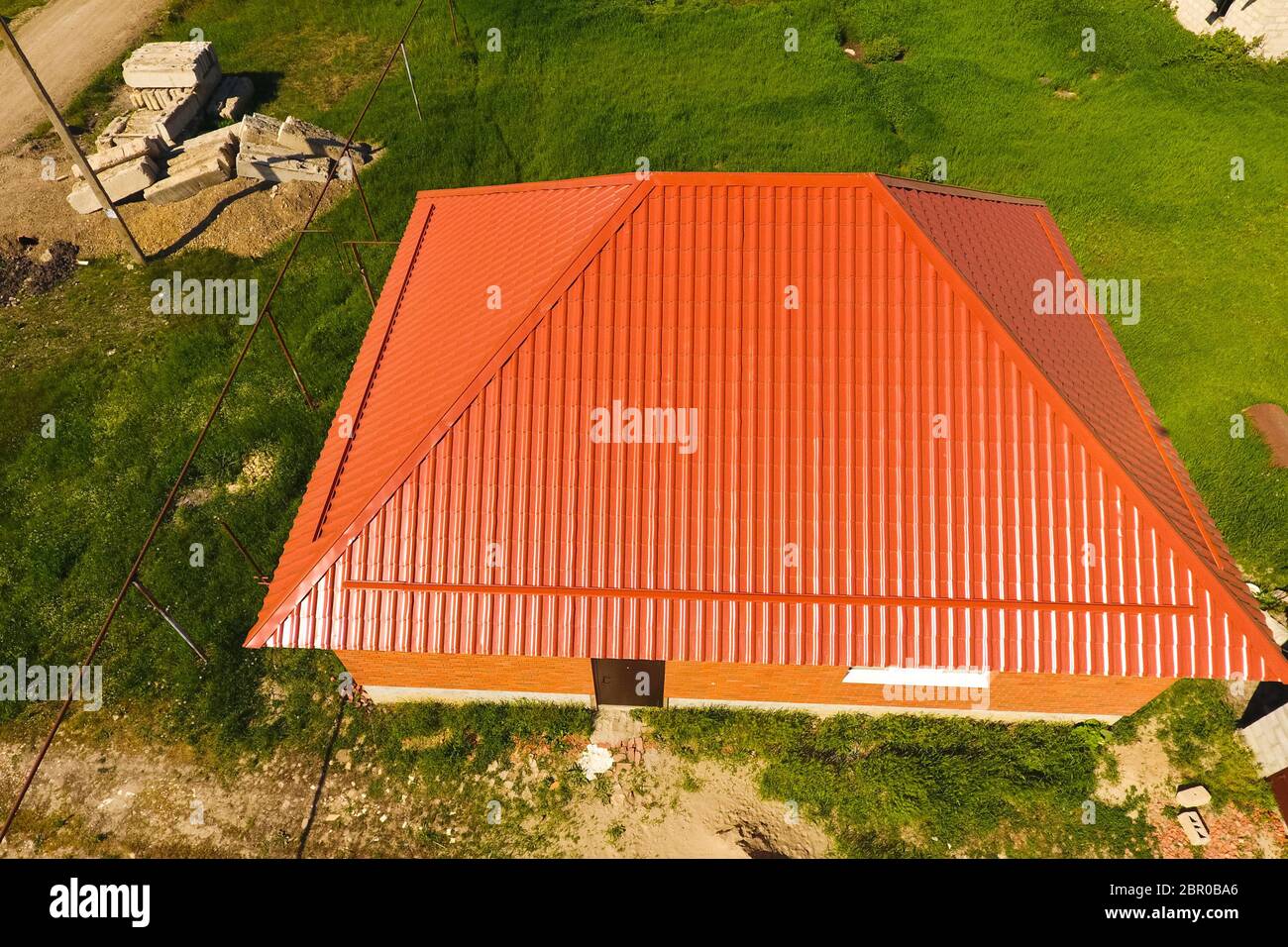 House with an orange roof made of metal, top view. Metallic profile ...