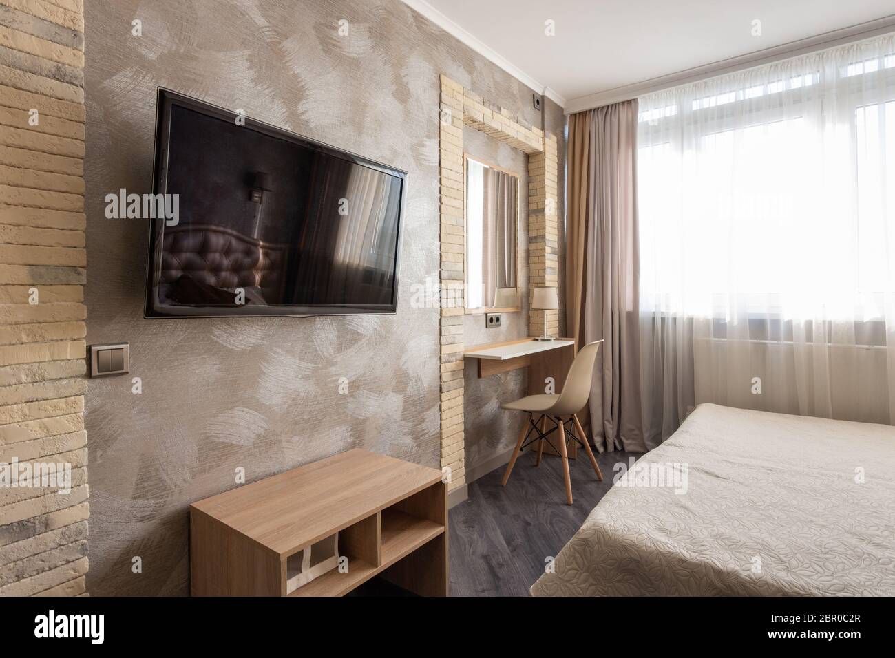 Interior of a bedroom, a fragment with a TV and a dressing table Stock ...