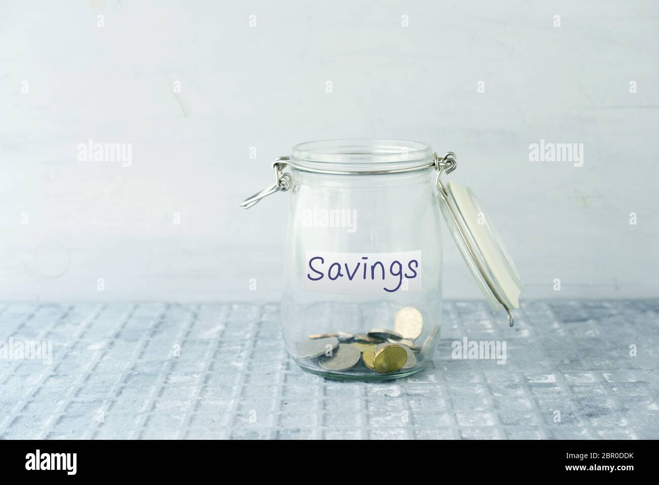 Coins in glass money jar with savings label, financial concept Stock ...