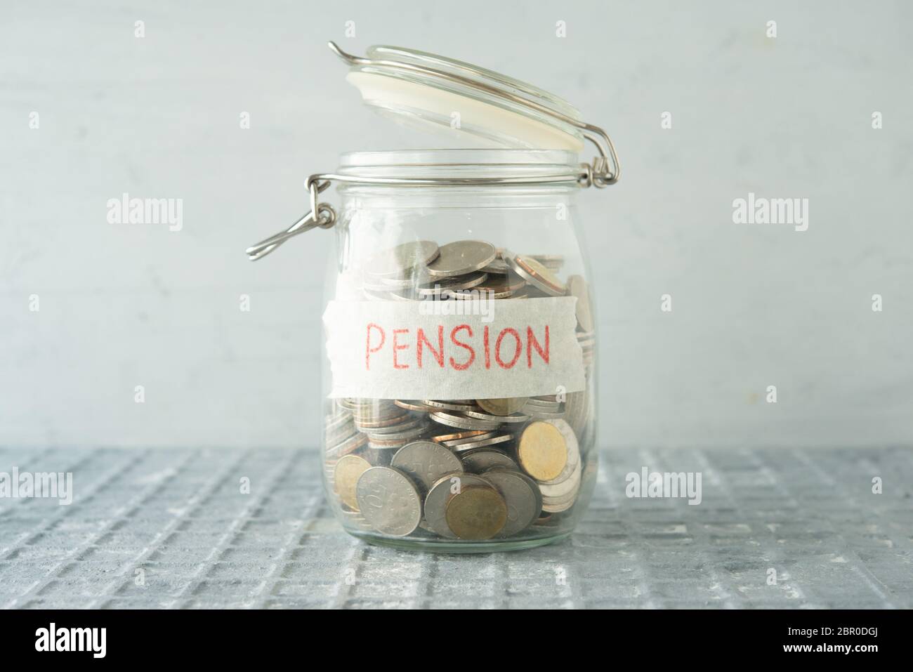 Coins in glass money jar with pension label, financial concept Stock ...