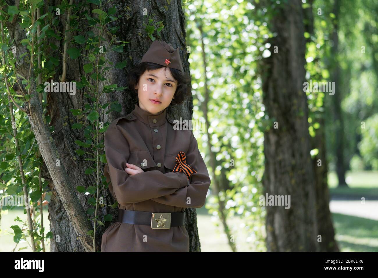 Portrait of a boy in the uniform of a soldier of the Red Army during ...