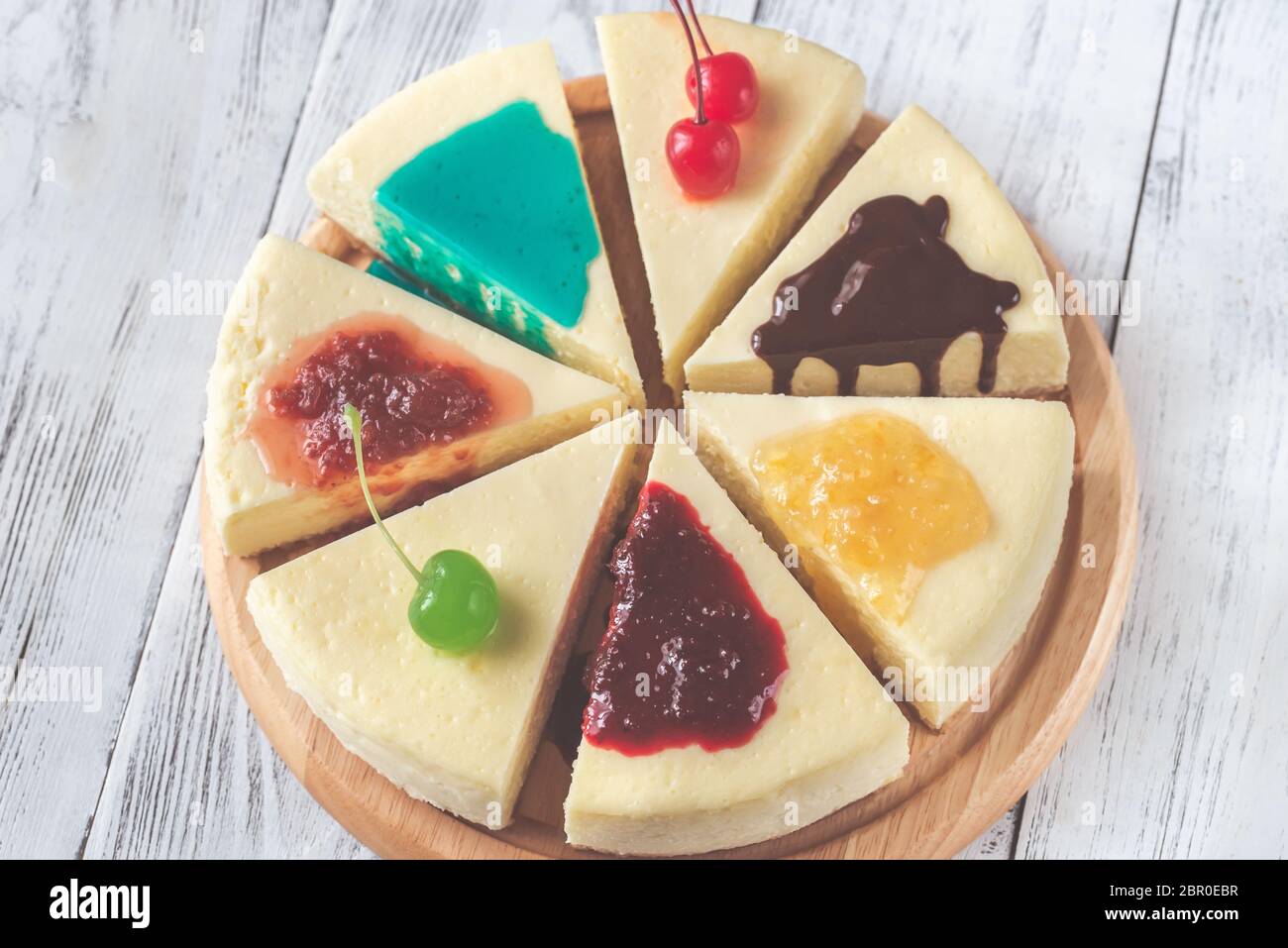 Pieces of cheesecake with different toppings Stock Photo - Alamy