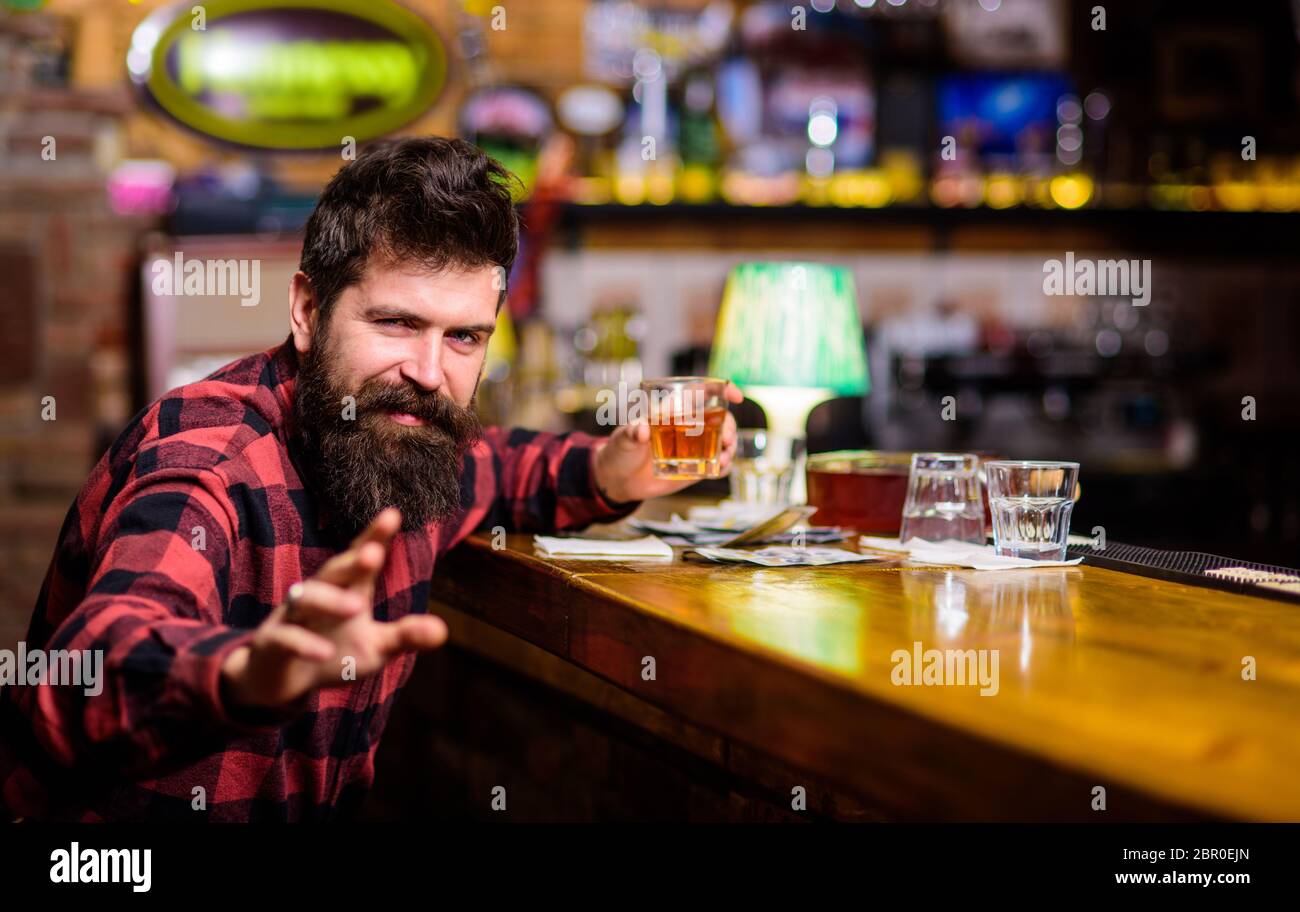 Drunk and relaxed concept. Man with drunk face sit alone in bar or pub ...