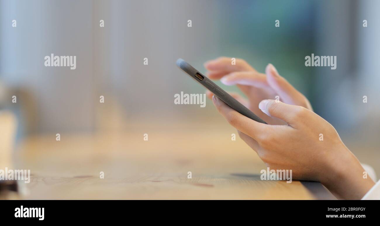 Woman use of smart phone with blur background Stock Photo - Alamy