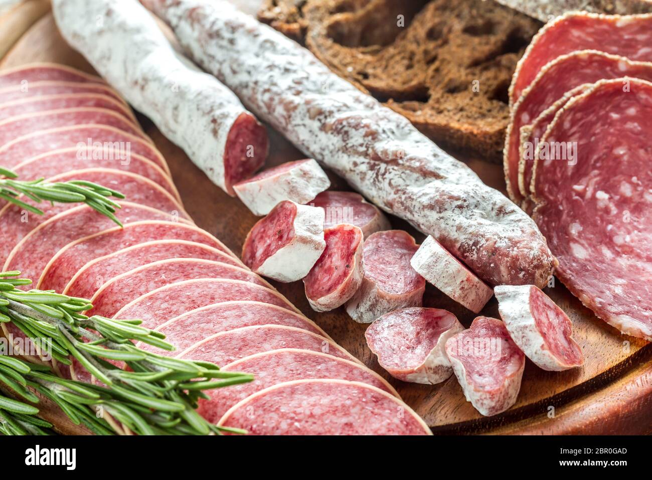 Different kinds of salami with dark-rye bread Stock Photo - Alamy
