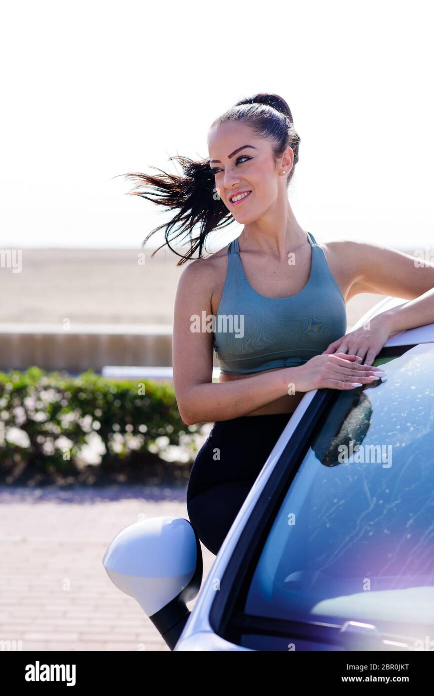 Young pretty women leaning out of car window Stock Photo - Alamy