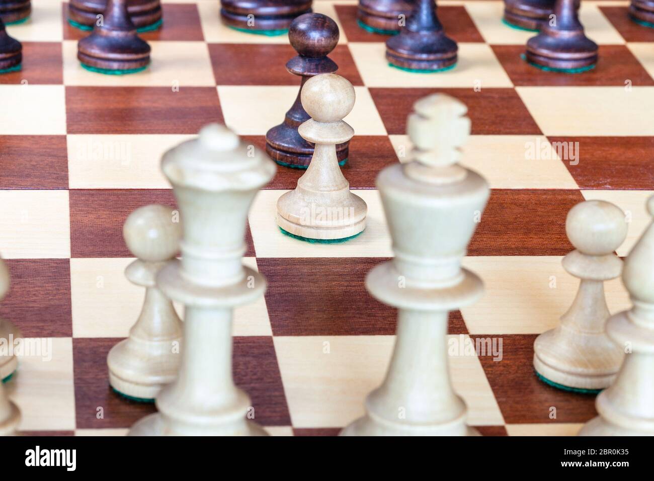 view from white side of first chess pawn moves close up on chessboard ...