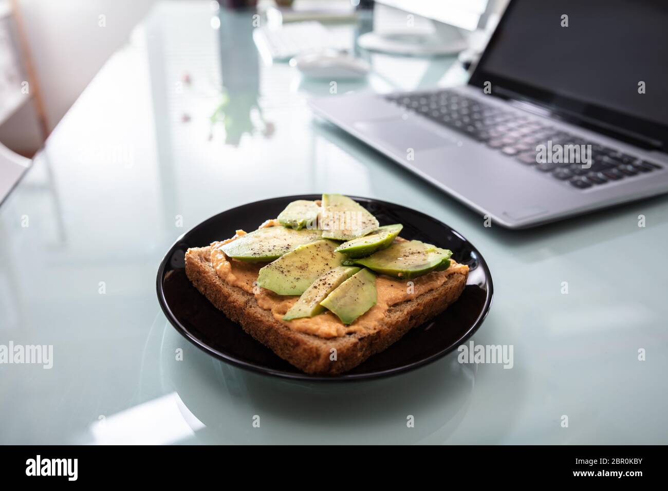 Healthy Sandwich In Plate Near Laptop Over Reflective Desk Stock Photo ...