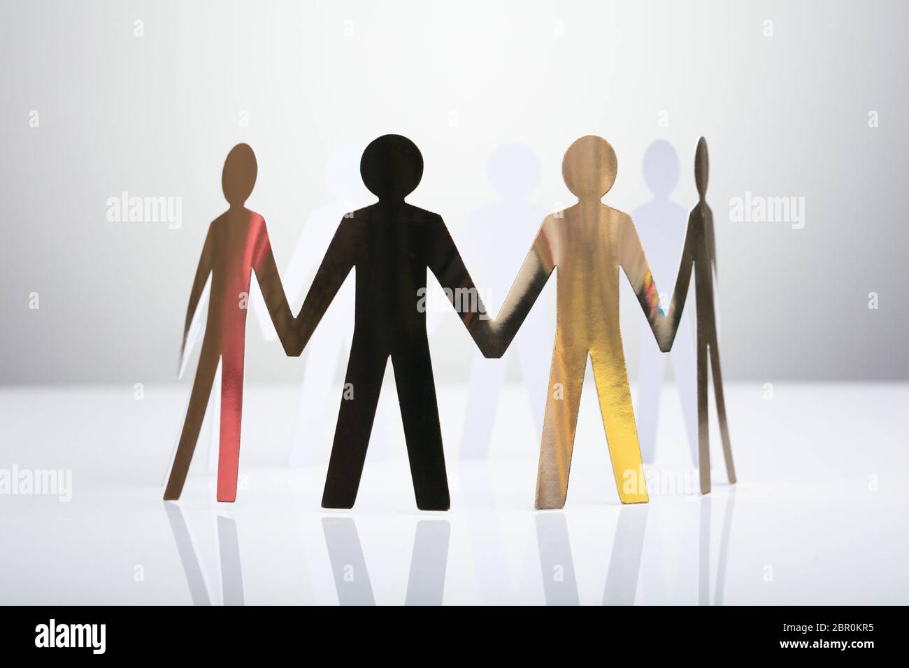 Close-up Of Human Figures Holding Their Hands Standing On White ...