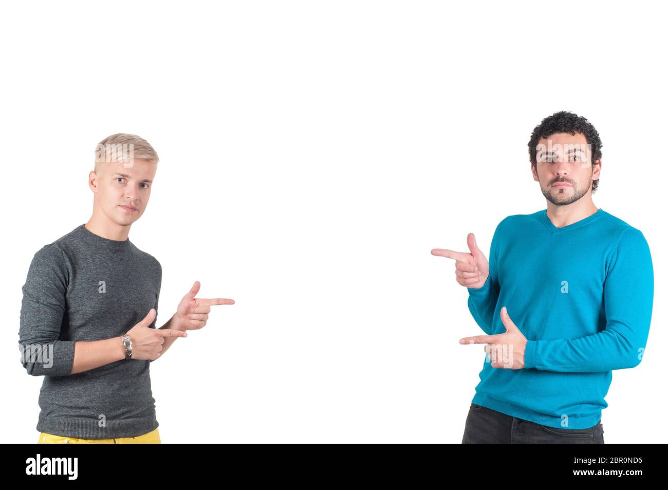 Two handsome guys showing somewhere with fingers, isolated on white ...