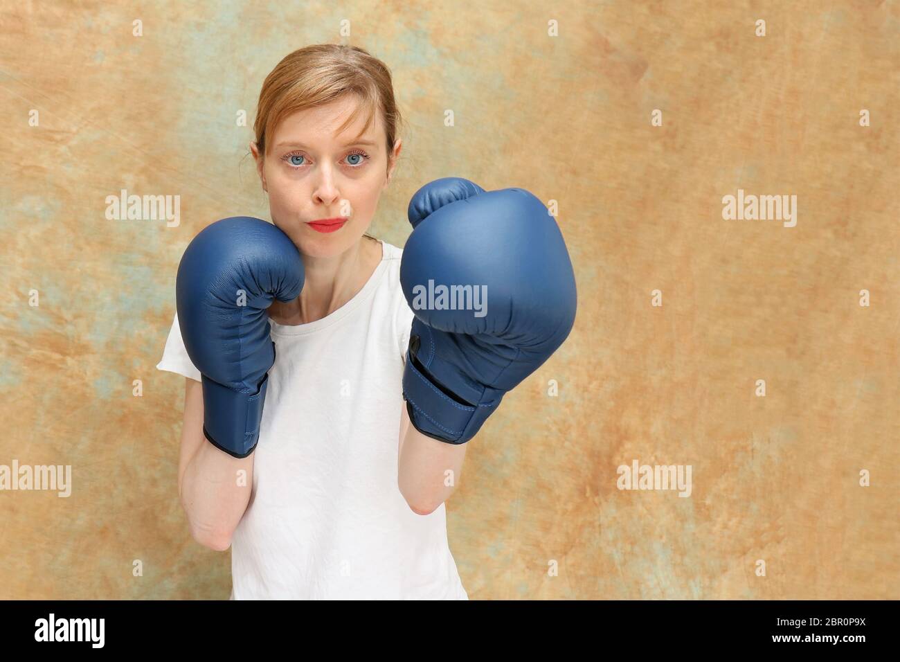 Blonde blue eyed girl with boxing gloves inside studio Stock Photo - Alamy