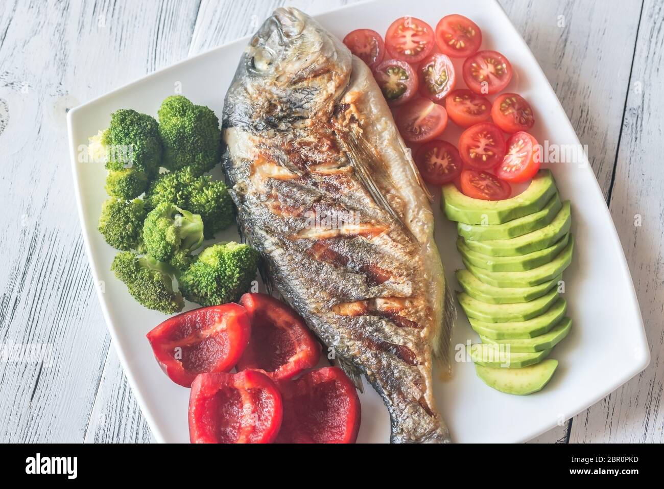 Grilled sea bream fish with vegetables Stock Photo - Alamy