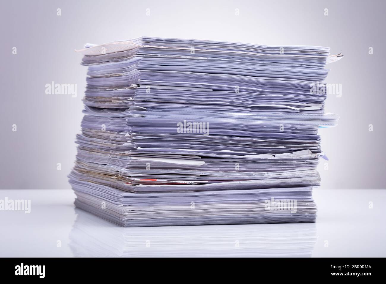 Photo Of Stacked Document Paper On Reflecting Backdrop Stock Photo - Alamy