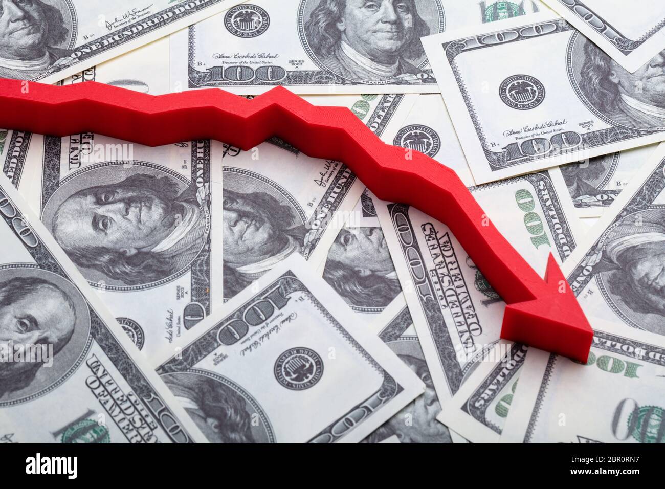 High Angle View Of A Red Decreasing Arrow Sign Over Banknotes ...