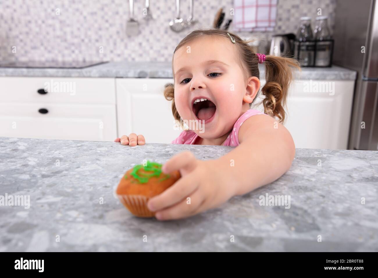 Hand reaching cake hi-res stock photography and images - Alamy