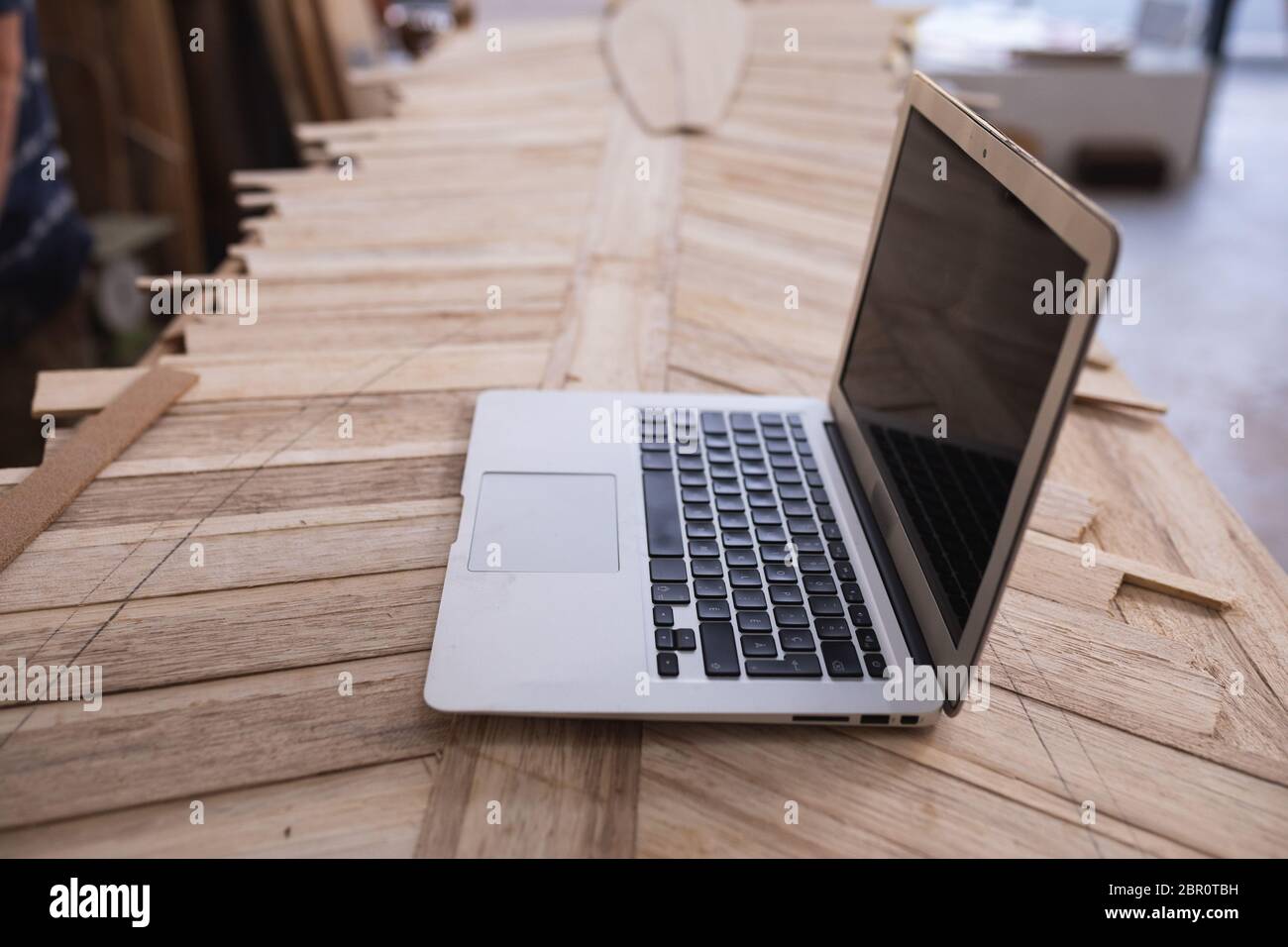 Laptop computer put on a surfboard in construction in a surfboard ...